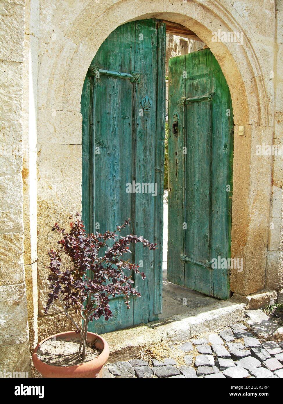 Ancient handcrafted stone arched entrance door in the historic village ...