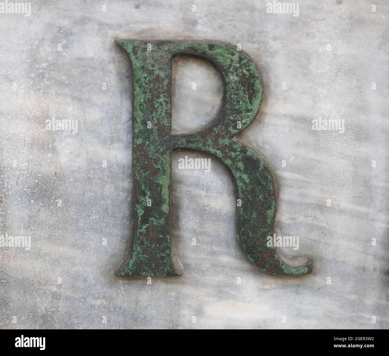 capital letter R cast in bronze on marble background Stock Photo - Alamy
