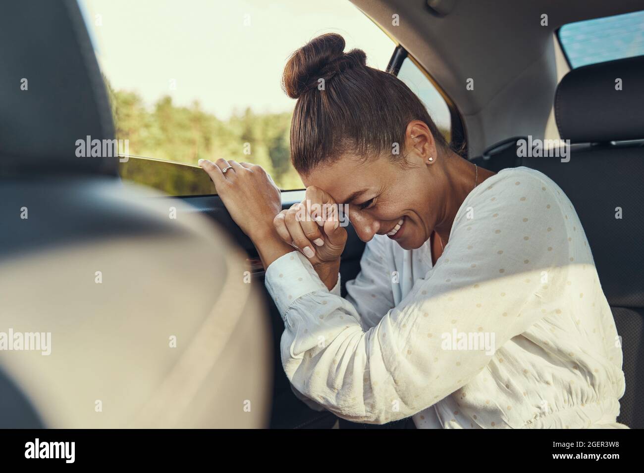 Passenger having fun at the back seat of car Stock Photo - Alamy