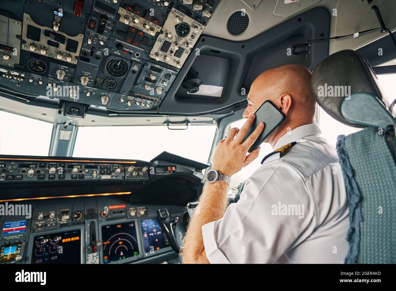 Male pilot having a phone conversation in the flight deck Stock Photo ...
