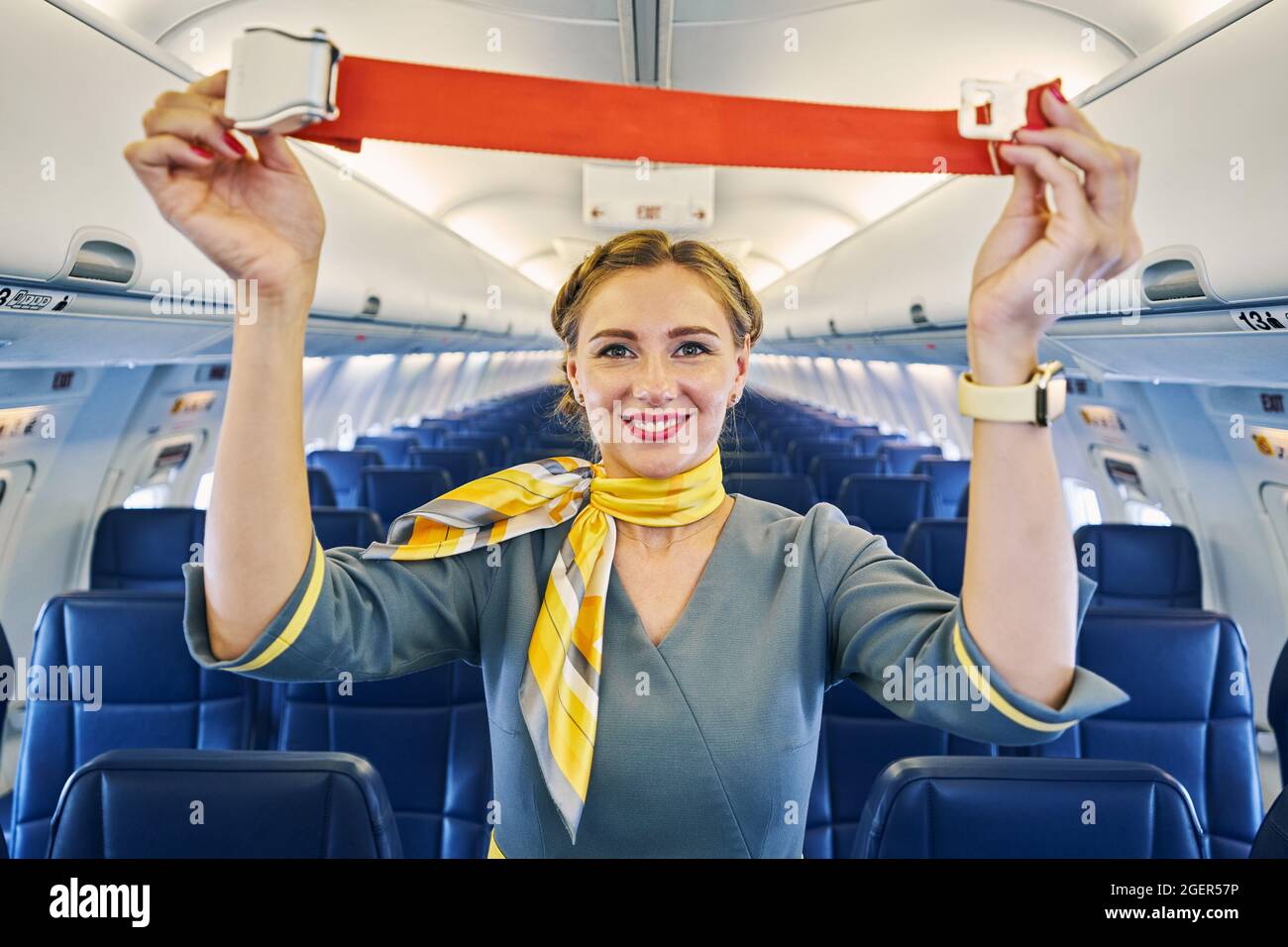 Air hostess performing a pre-flight safety demonstration before the ...