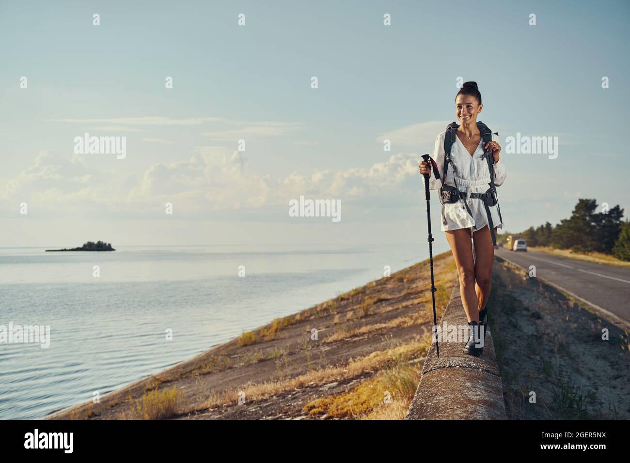 Tourist walking on top of stone road barrier Stock Photo - Alamy