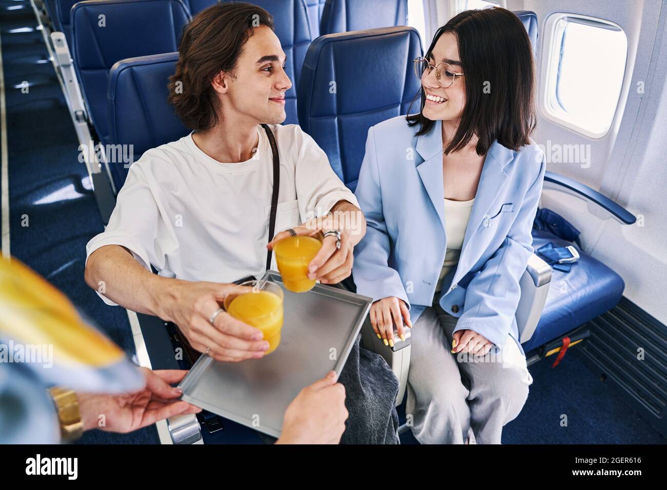 First class passengers being served a citrus drink Stock Photo - Alamy