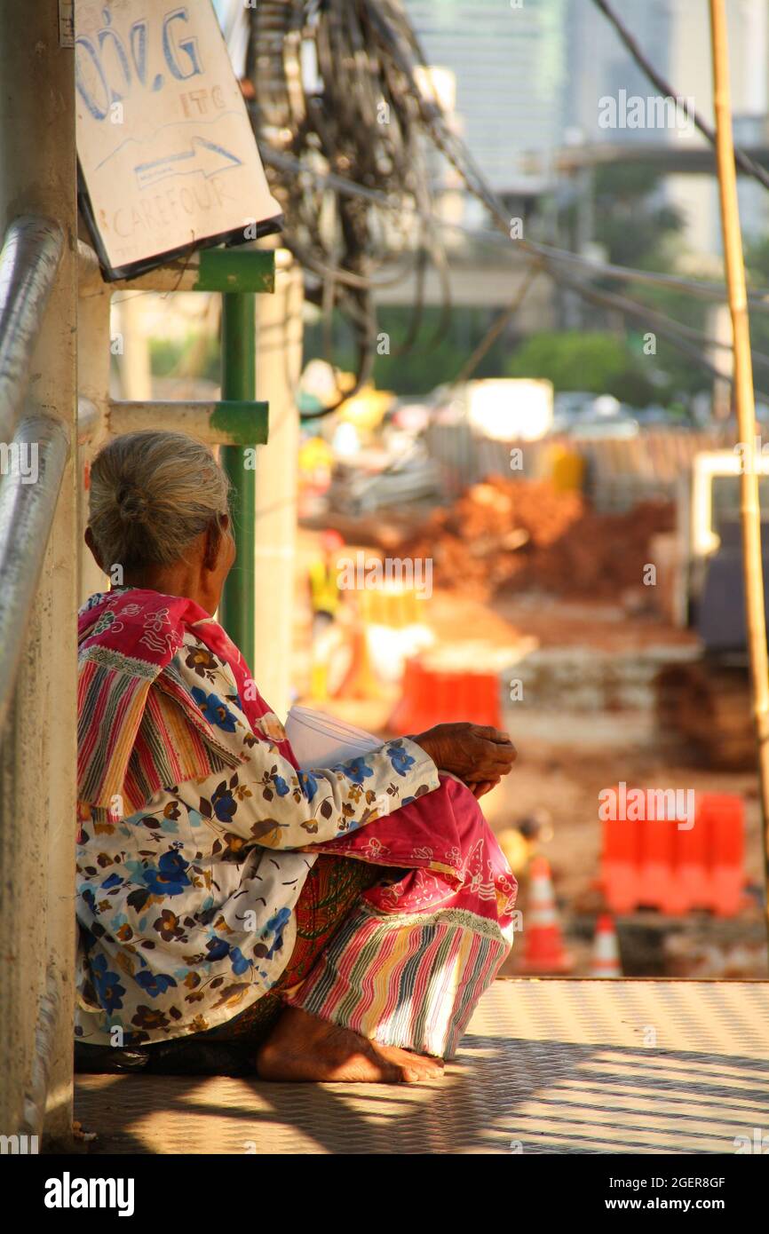 Old woman homeless sitting on hi-res stock photography and images - Alamy