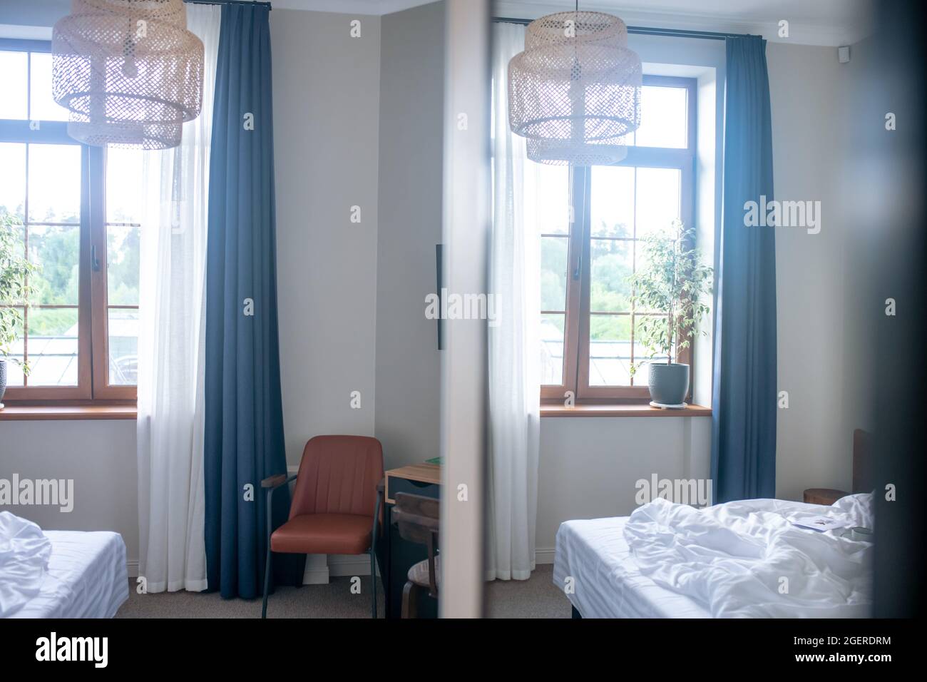 Bed and window reflecting in mirror Stock Photo - Alamy