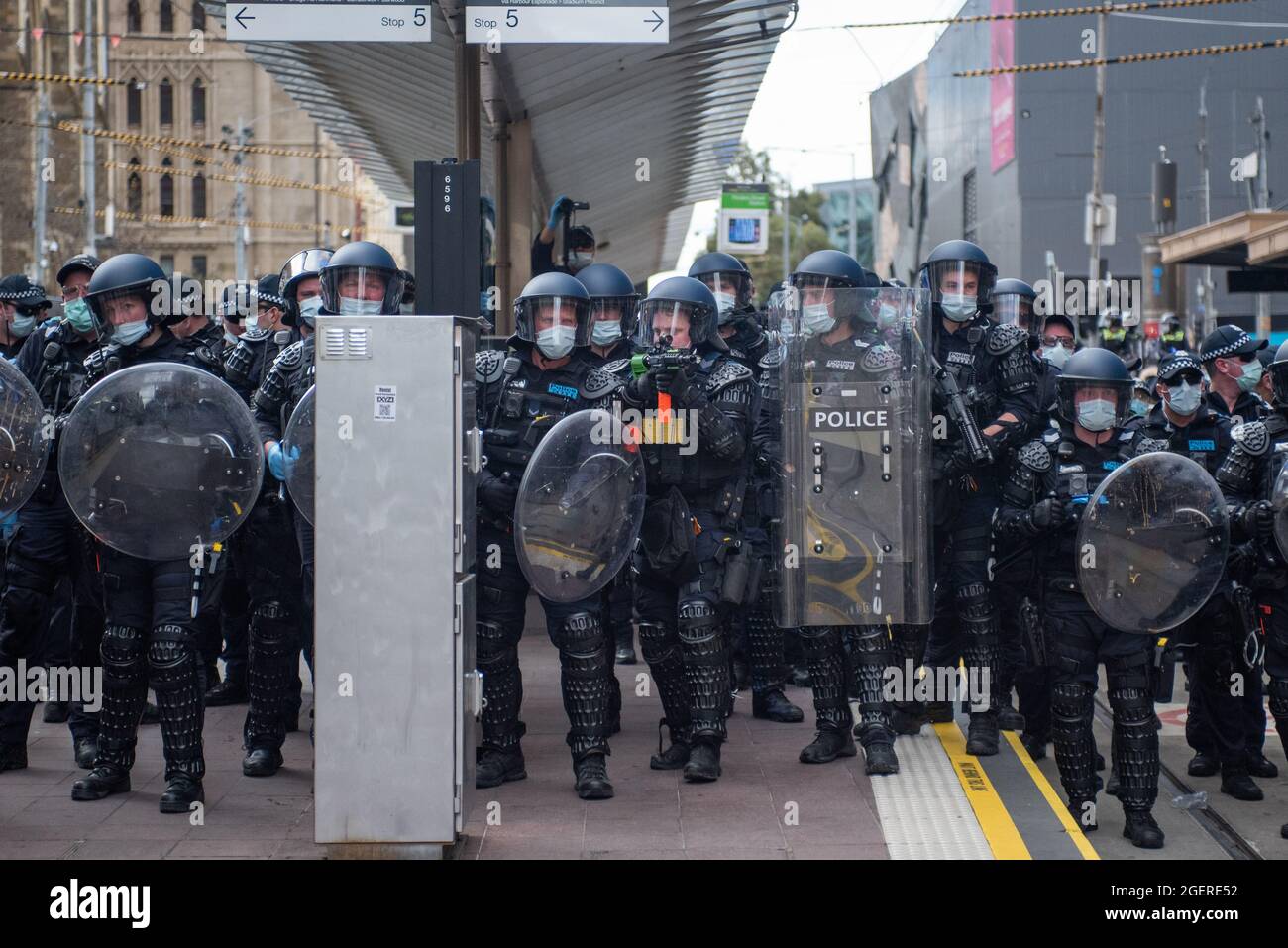 Melbourne, Australia. 21st August 2021. Riot squad officers move ...
