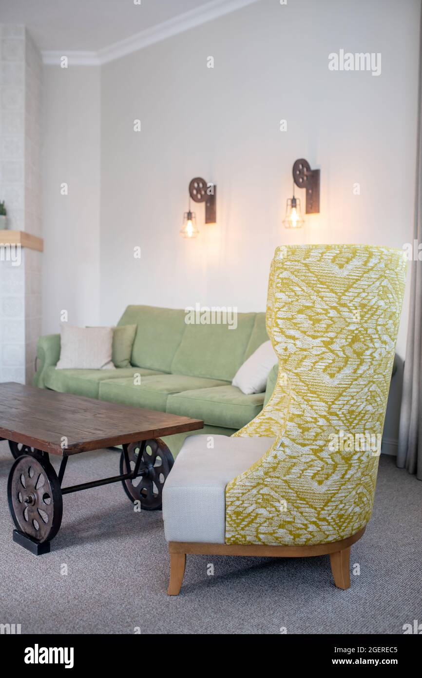 High back upholstered armchair in living room Stock Photo - Alamy