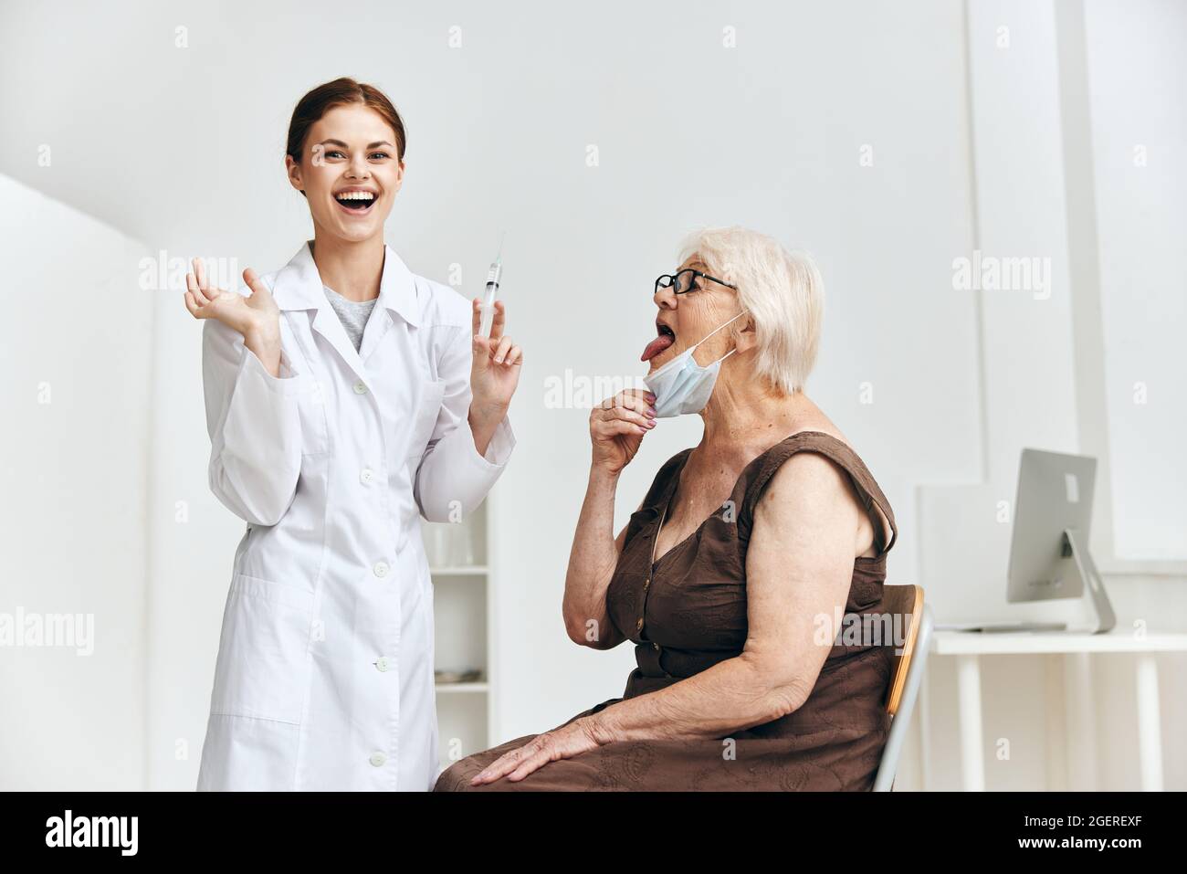 emotional nurse and patient injection into hospital arm Stock Photo - Alamy