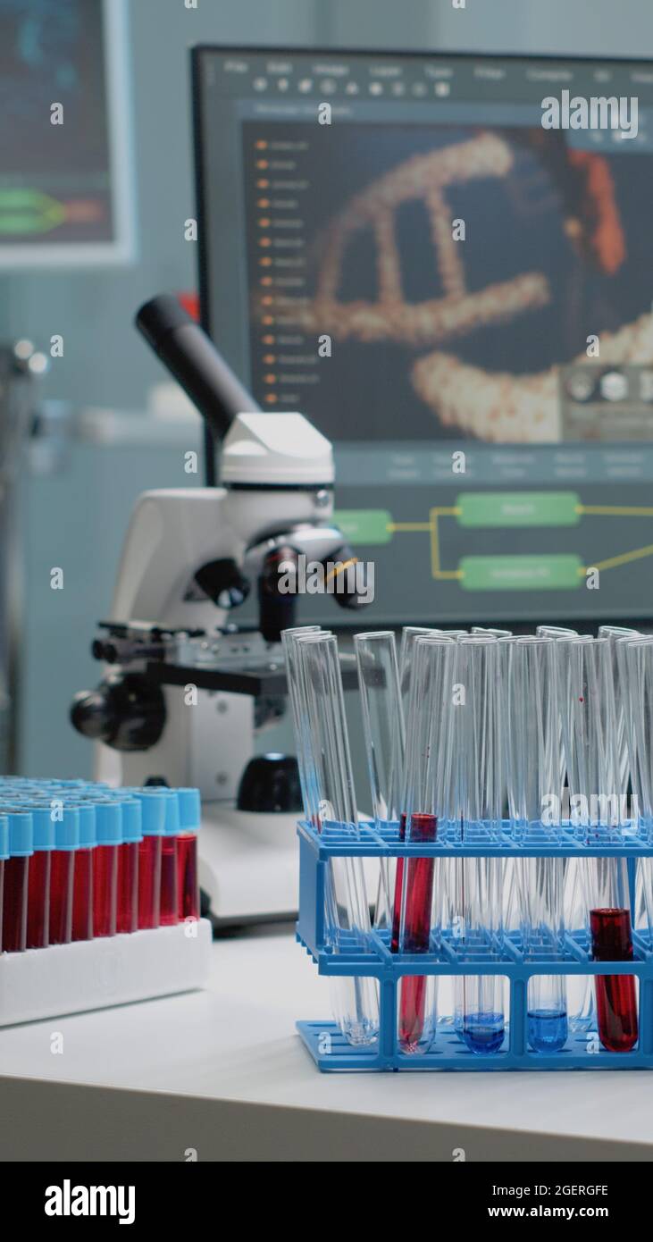 Medical test tubes with blood on desk in laboratory at research clinic ...
