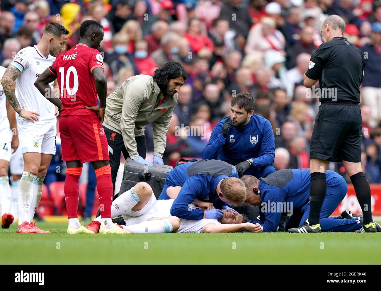 Burnley's James Tarkowski lies injured on the pitch during the Premier ...