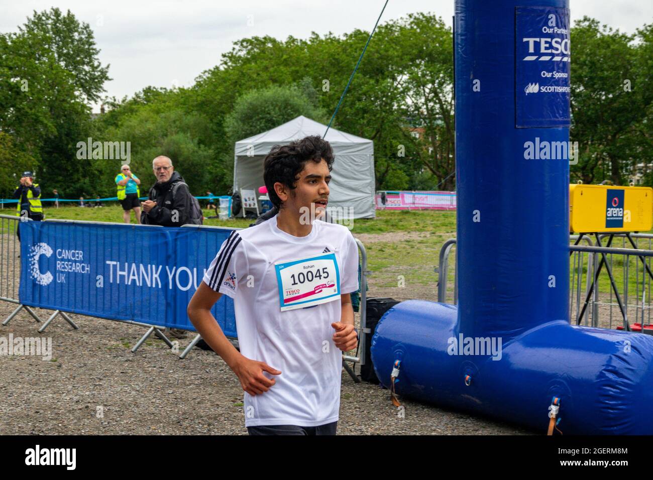 A man running the Cancer Research Race for Life on Hampstead Heath ...