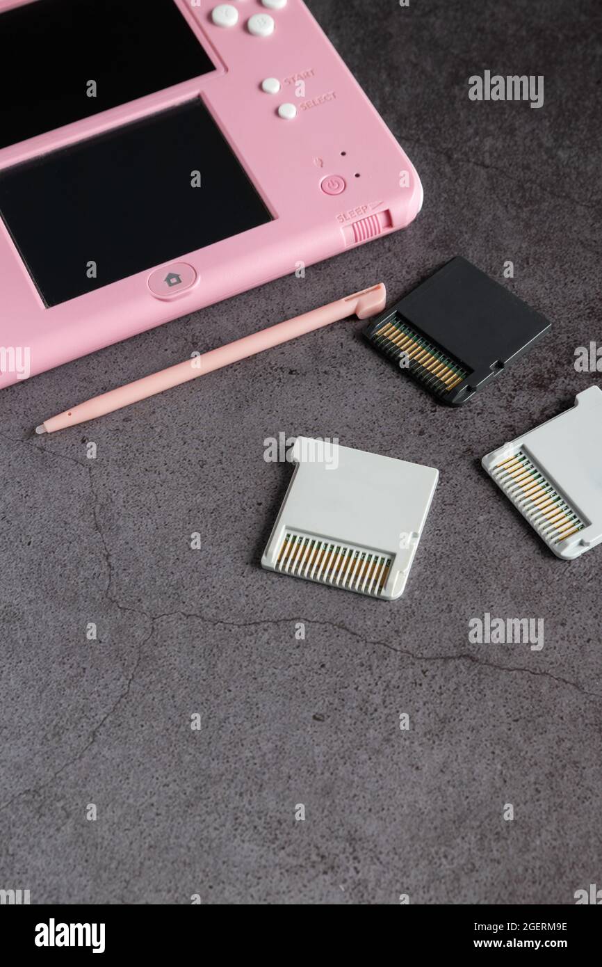 Pink portable game console with games on dark background Stock Photo ...