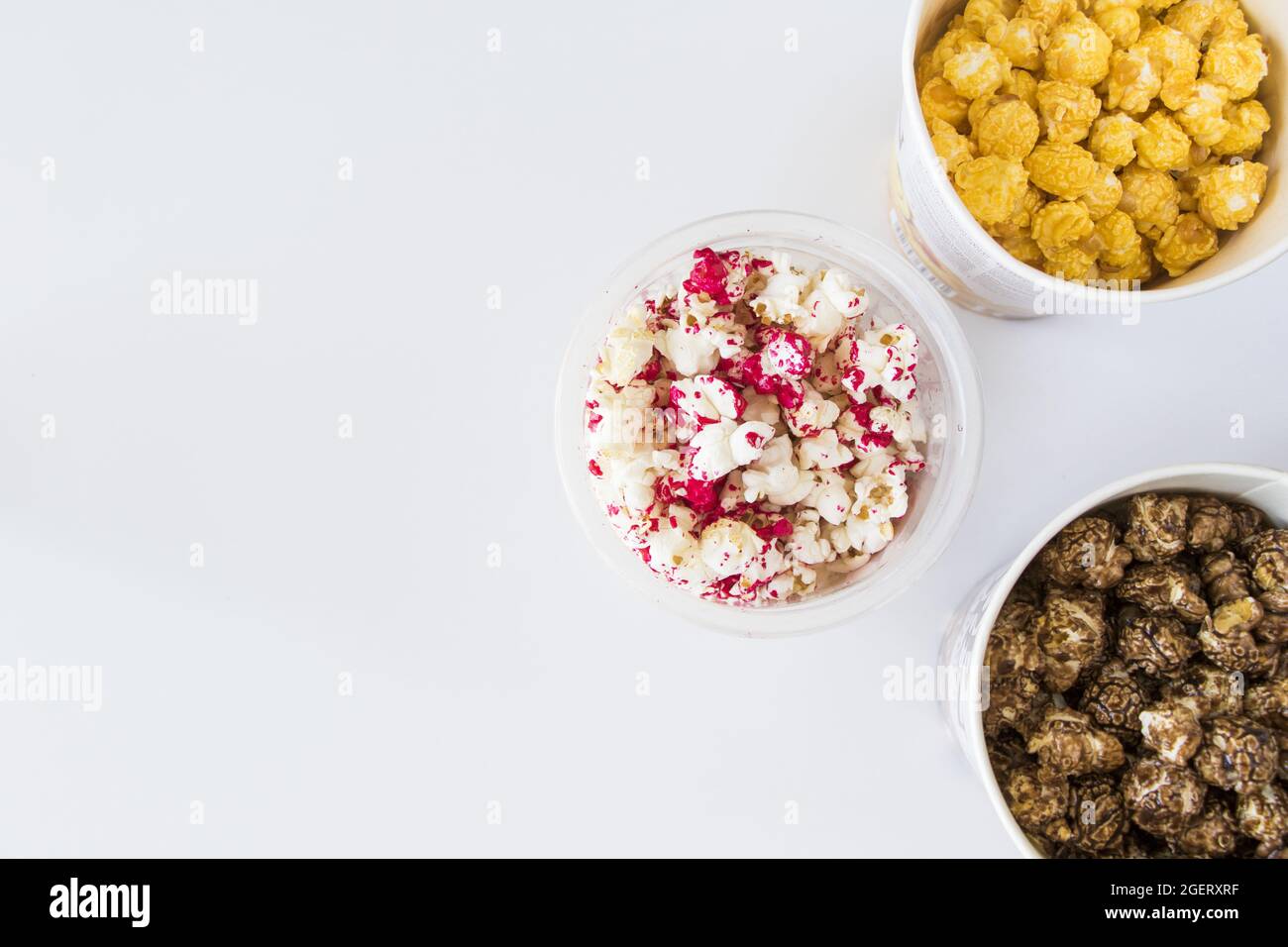 Top view shot of sweet fried popcorn in a bowl on the white background ...