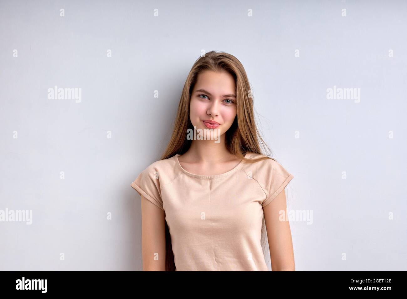 Portrait of shy caucasian teenage girl isolated on white background ...