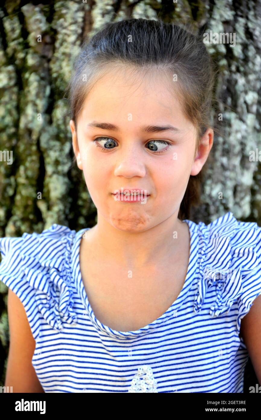 Little Girl makes an aweful face after smelling something dreadful. Her ...