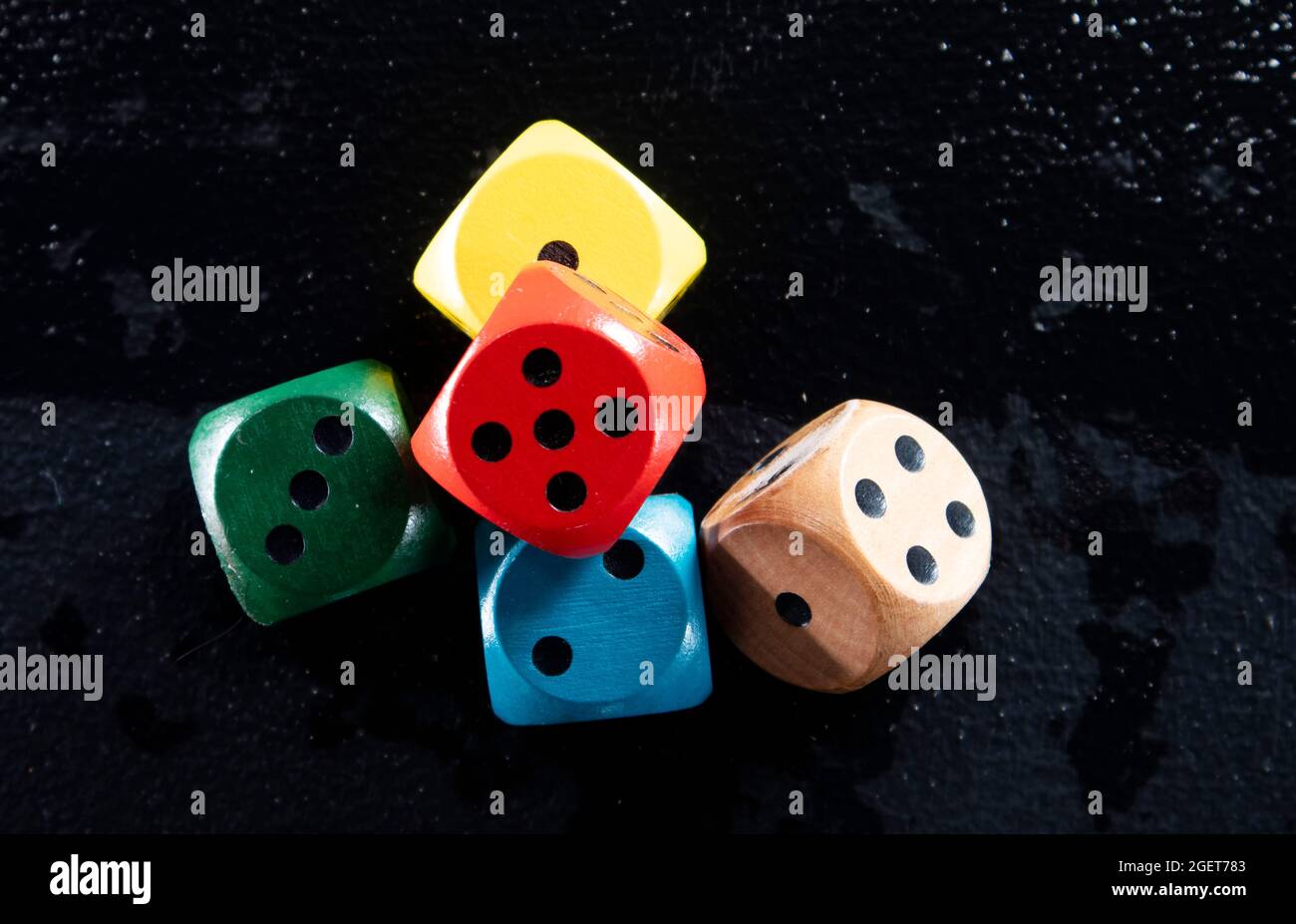 Representation of a set of colored game dice on a black background ...