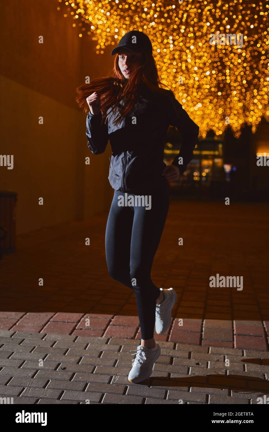 Sport woman running along night hi-res stock photography and images - Alamy