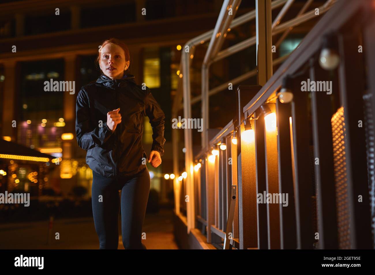 Attractive Slim Fitness Woman in Black Athletic Wear is Jogging In ...