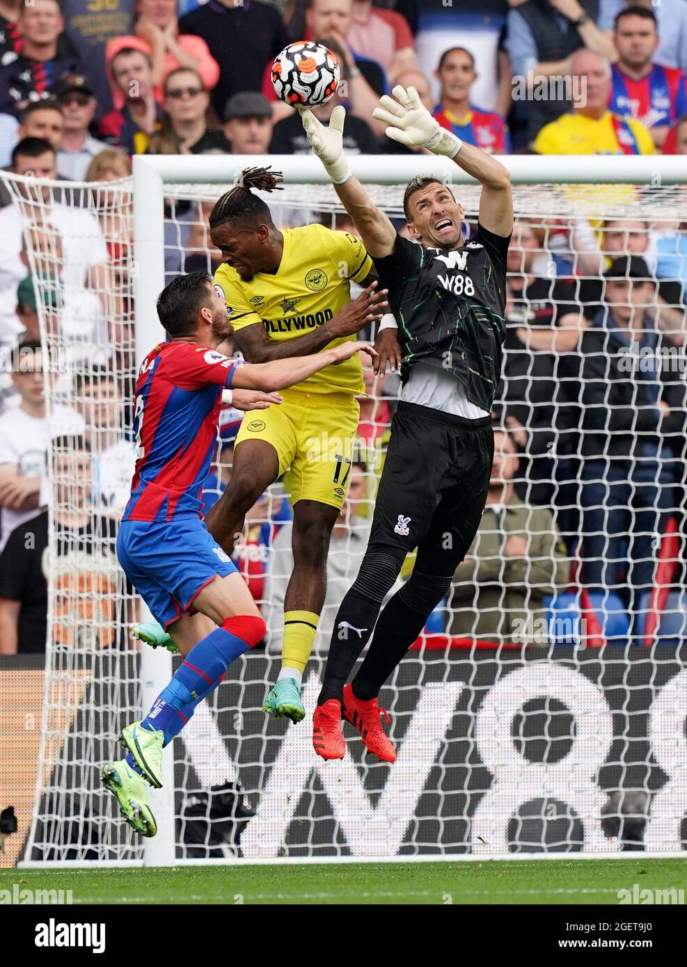 Brentford's Ivan Toney (centre) and Brentford goalkeeper David Raya Martin (right) battle for ...