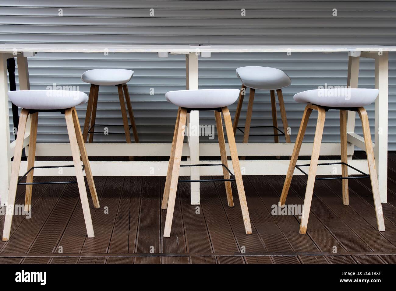 Scandinavian style bar counter and tall stools in gray tones at the ...