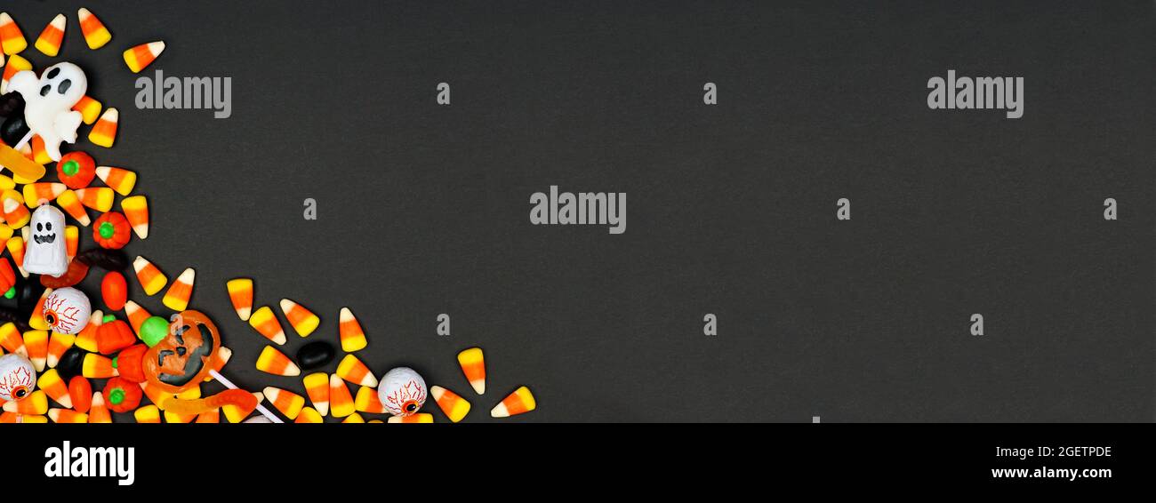 Halloween candy corner border banner. Top view on a black background ...