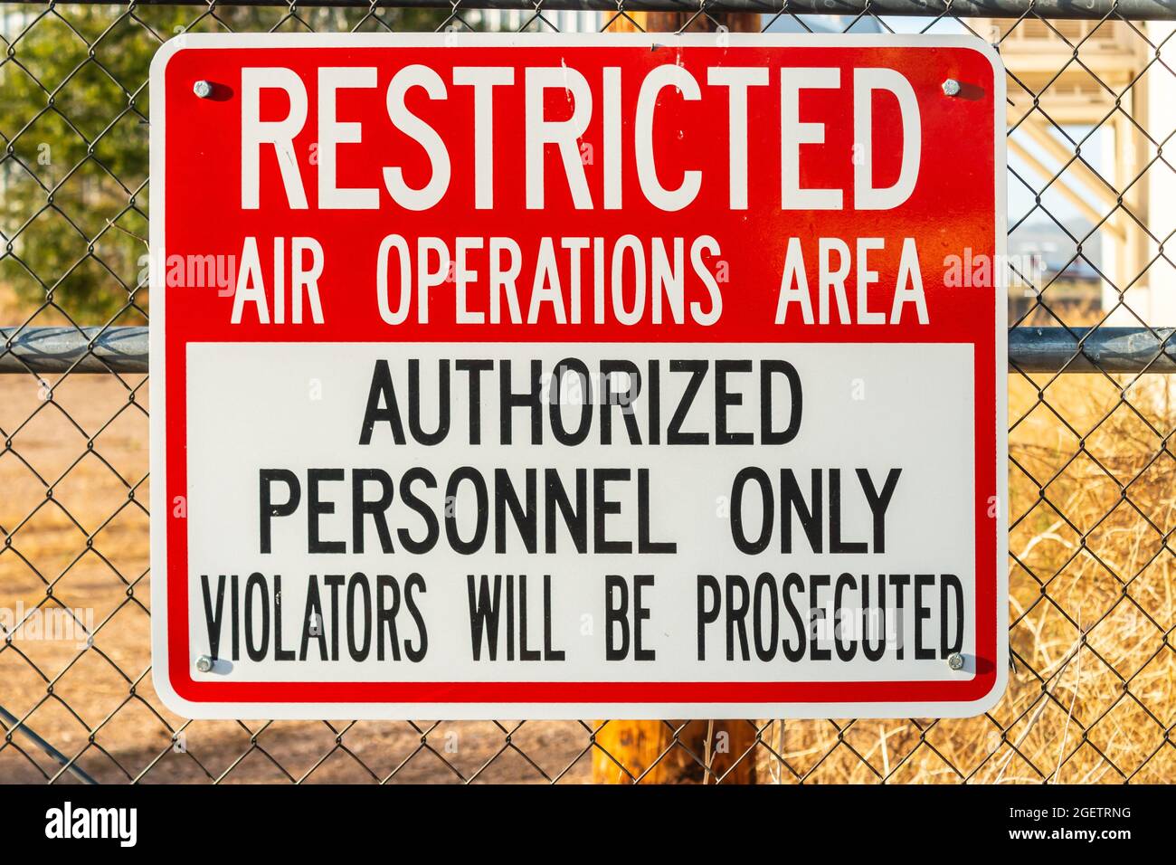 restricted operations sign on hurricane fence at airport in Kingman Arizona Stock Photo - Alamy