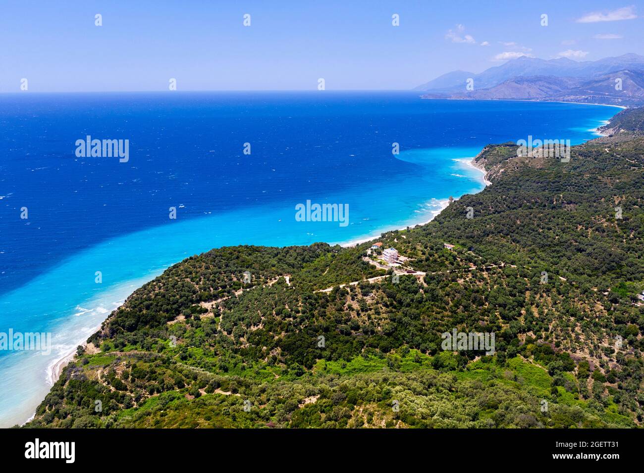 Aerial view of beautiful sandy beach with olive trees on the Albanian ...