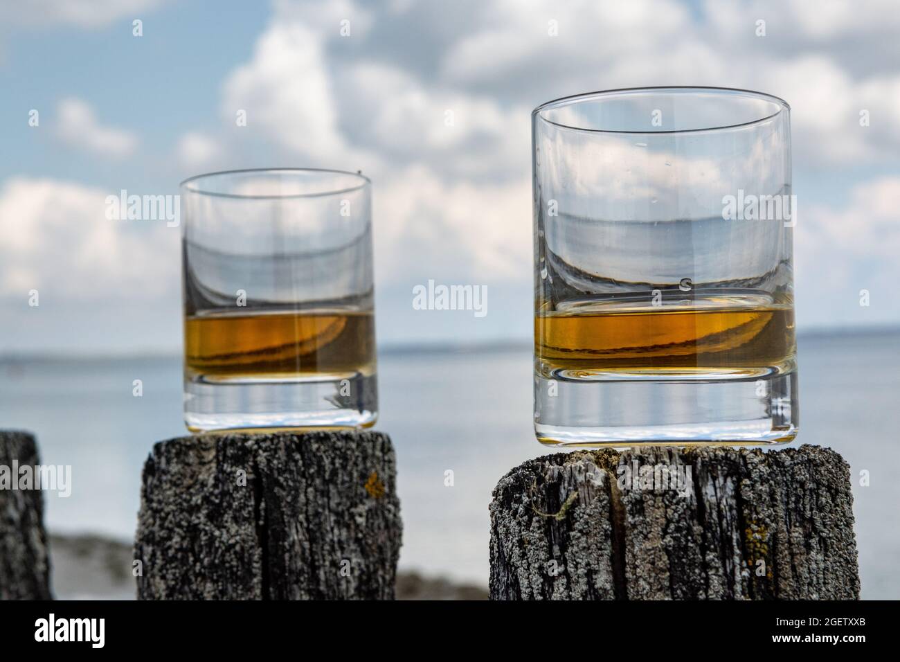 Tasting of dram single malt scotch whisky on seashore in Scotland, old ...