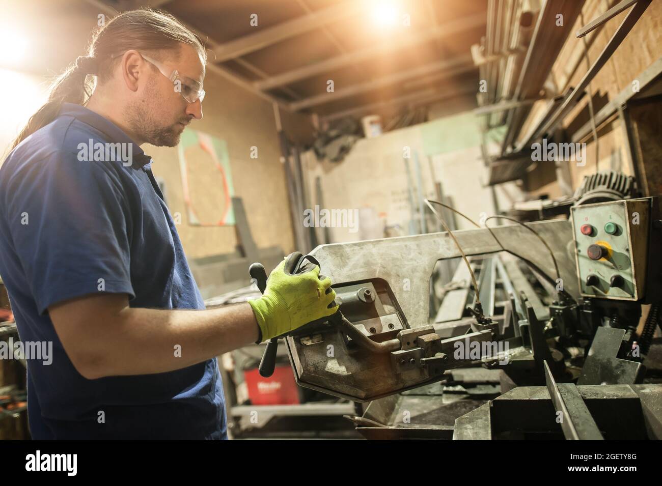 Craftsman worker working on steel structure in factory. Metal work ...