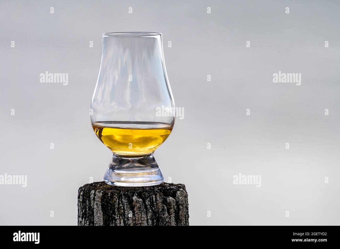 Tasting of dram single malt scotch whisky on seashore in Scotland, old ...