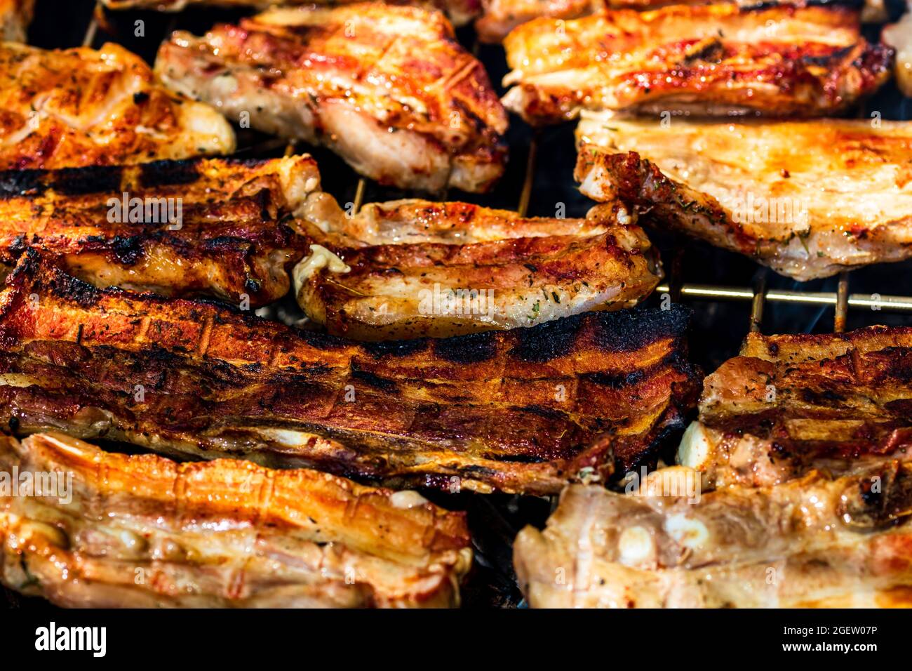 Closeup shot of assorted delicious grilled meat being cooked on a ...