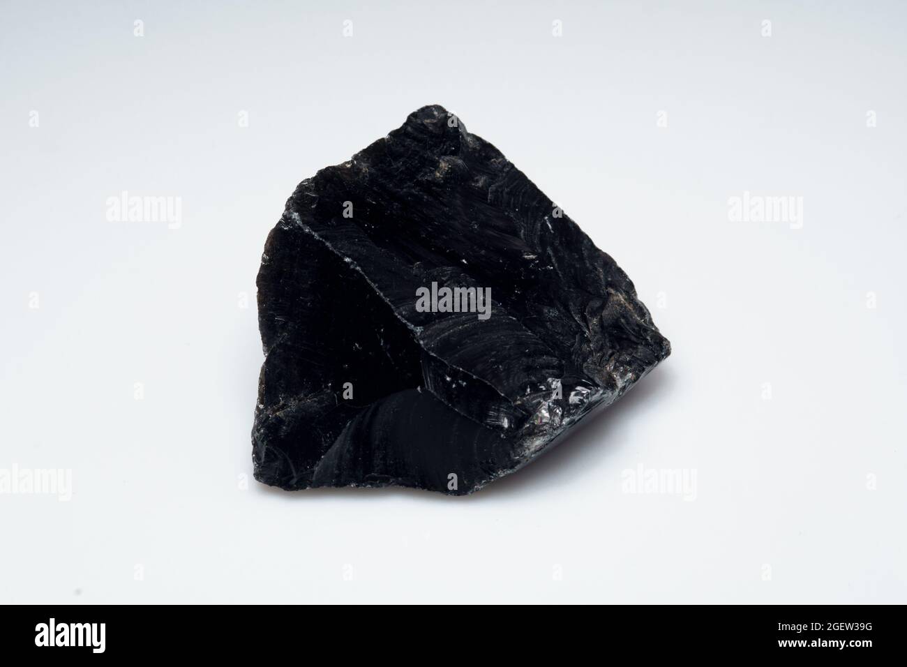 Natural black obsidian stone on background Stock Photo - Alamy