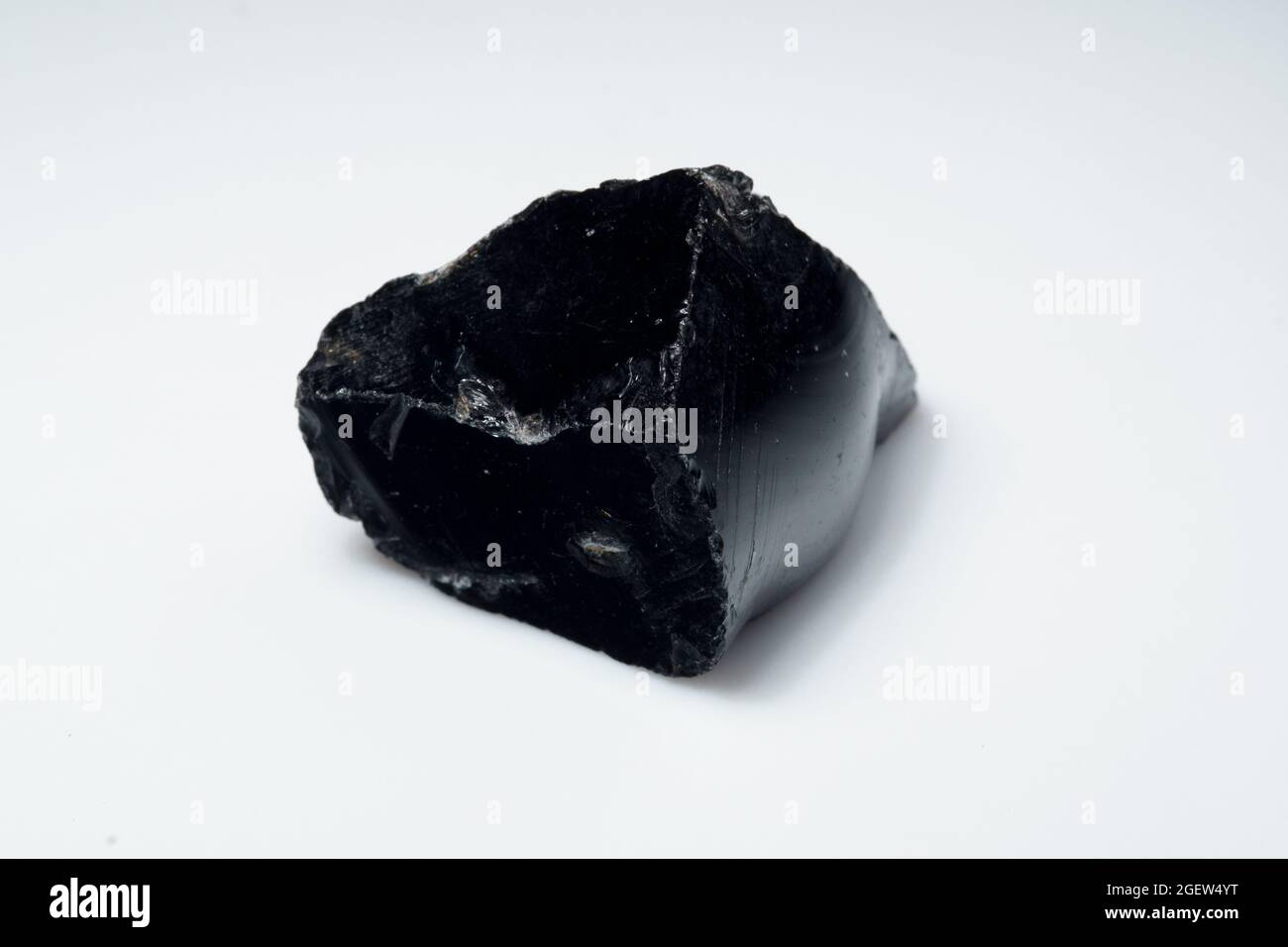 Natural black obsidian stone on background Stock Photo - Alamy