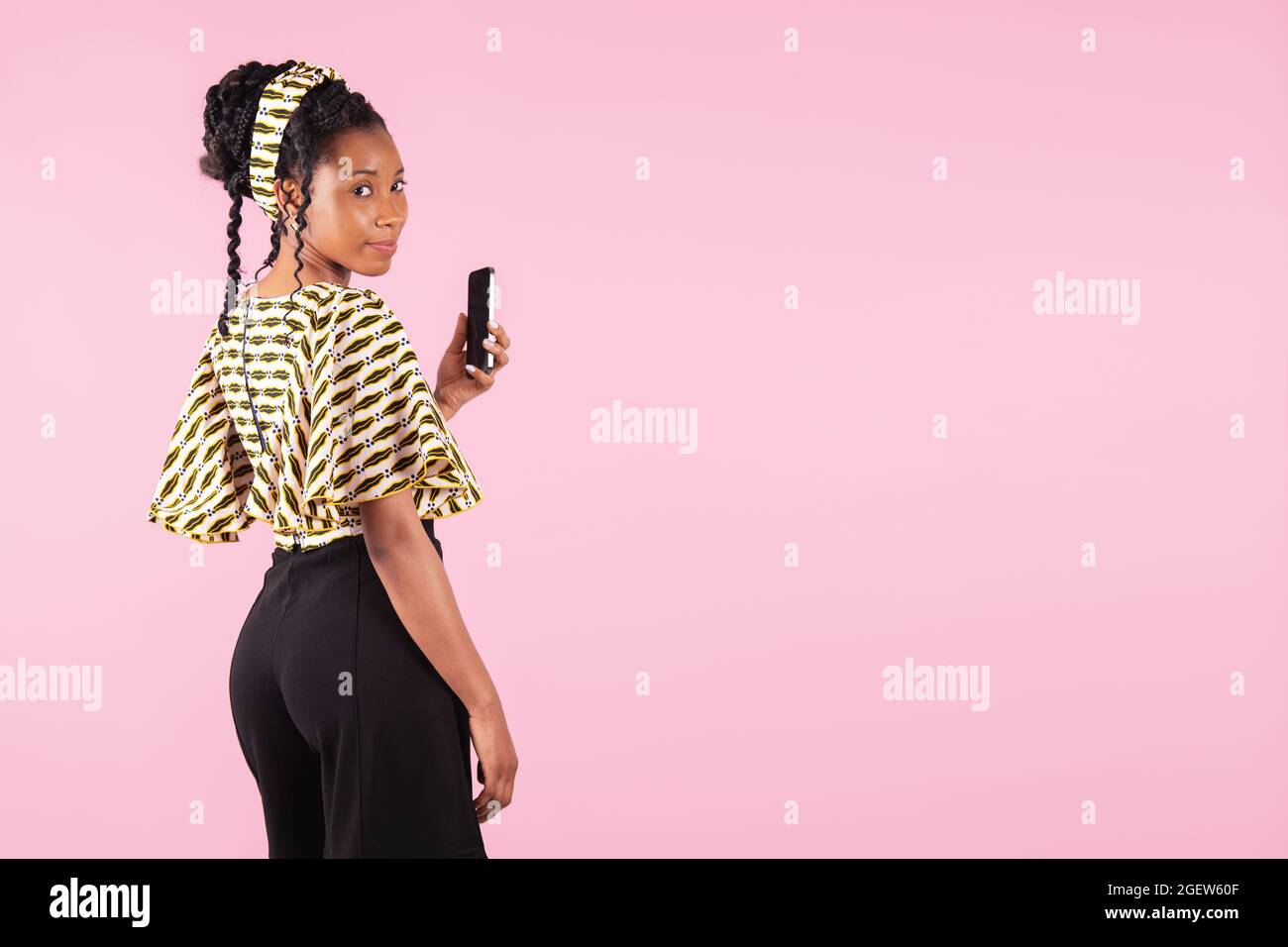 Afro american woman looking back at the camera Stock Photo - Alamy