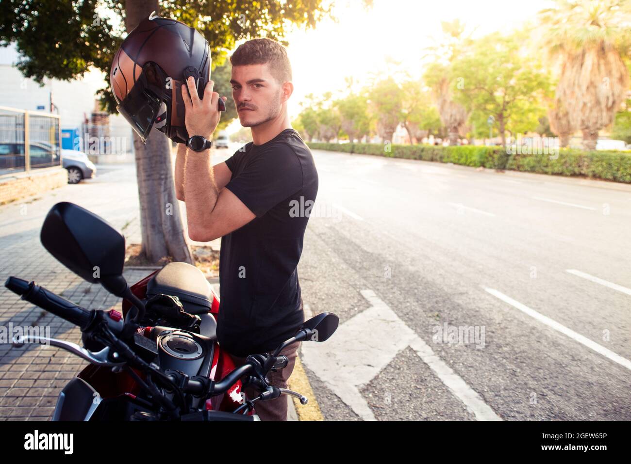 Person motorbike putting on helmet hi-res stock photography and images ...