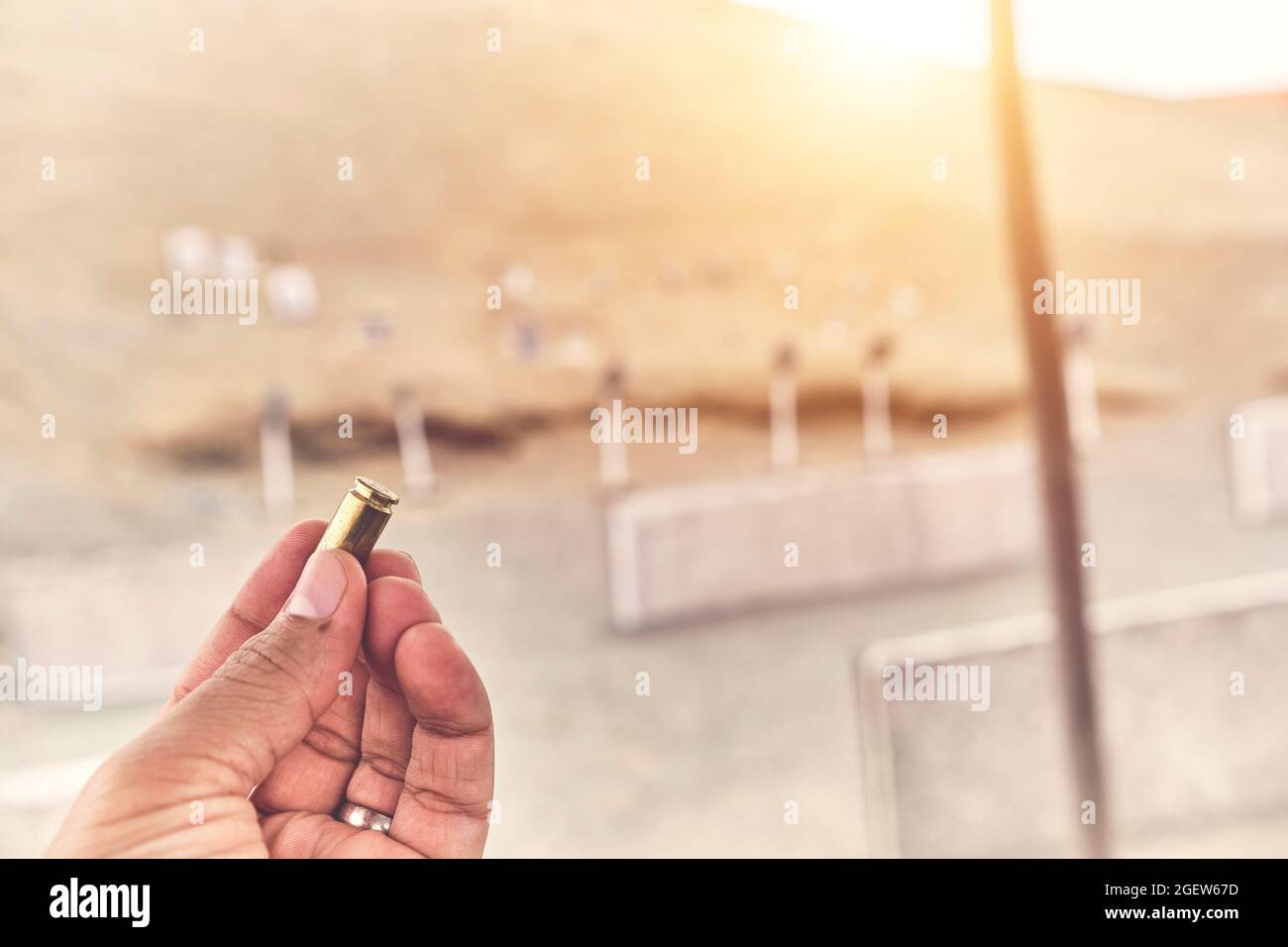 The power of a life in your fingers, holding a 9mm bullet Stock Photo ...
