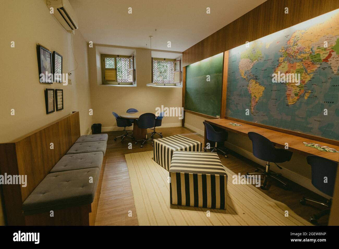 Interior of a cozy working space with a blackboard and a world map ...