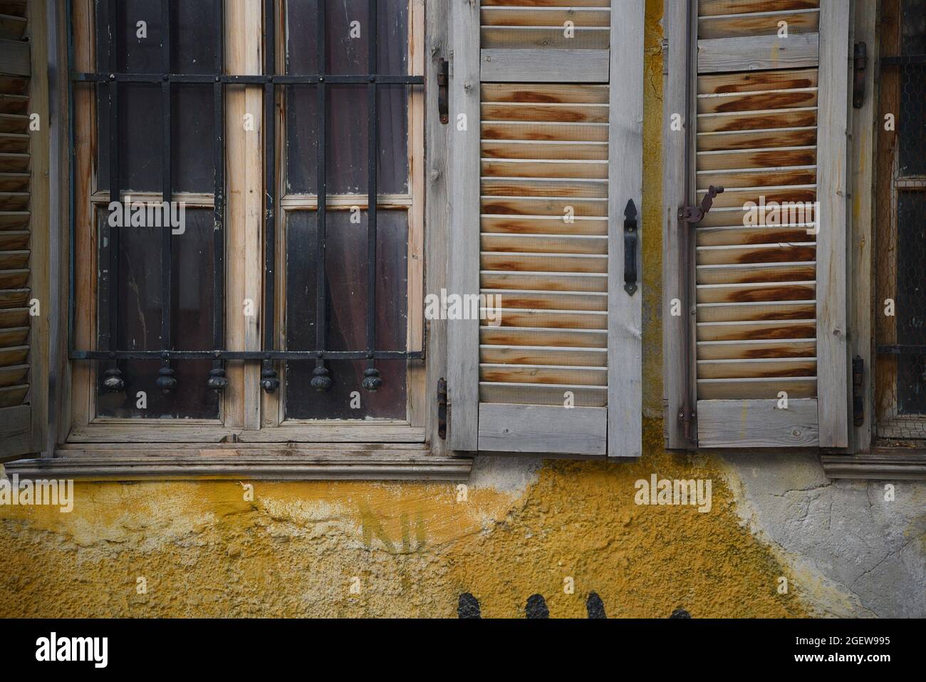 Old abandoned house antique window with aged wooden shutters and ...
