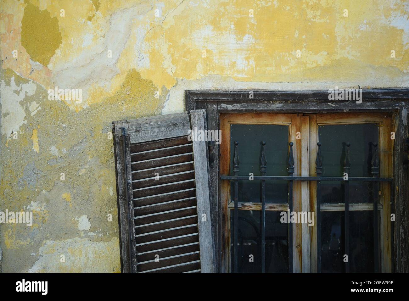 Old abandoned house antique window with aged wooden shutters and ...