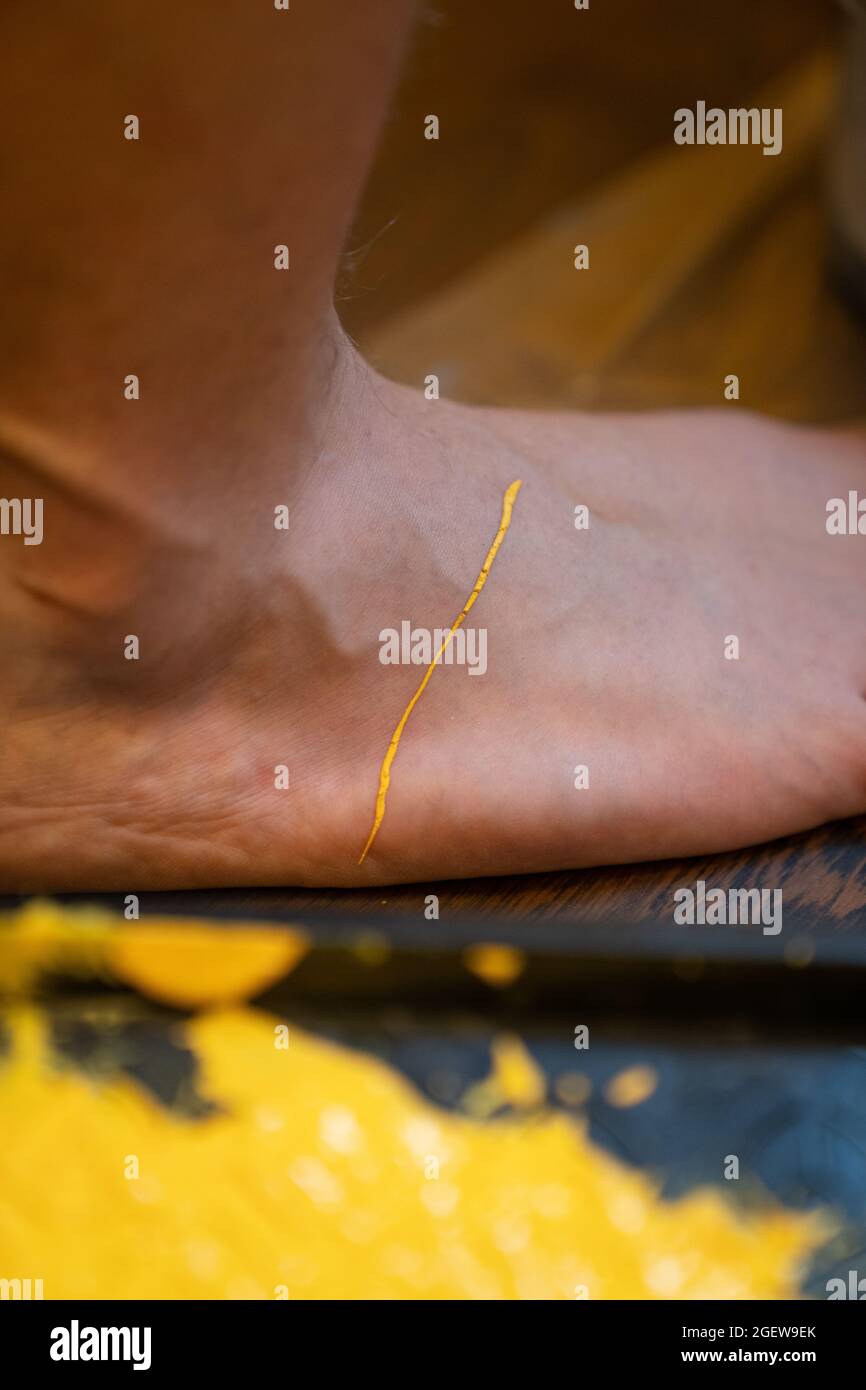 a yellow stripe on the man's leg during the repair of the room, yellow ...