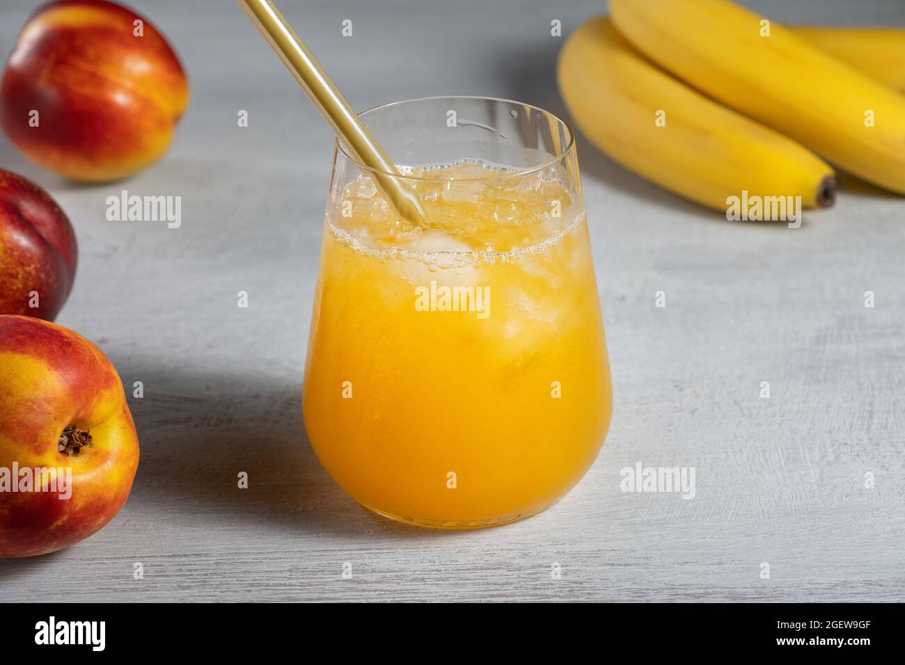 Multi fruit juice from orange, peach, banana in a glass Stock Photo - Alamy