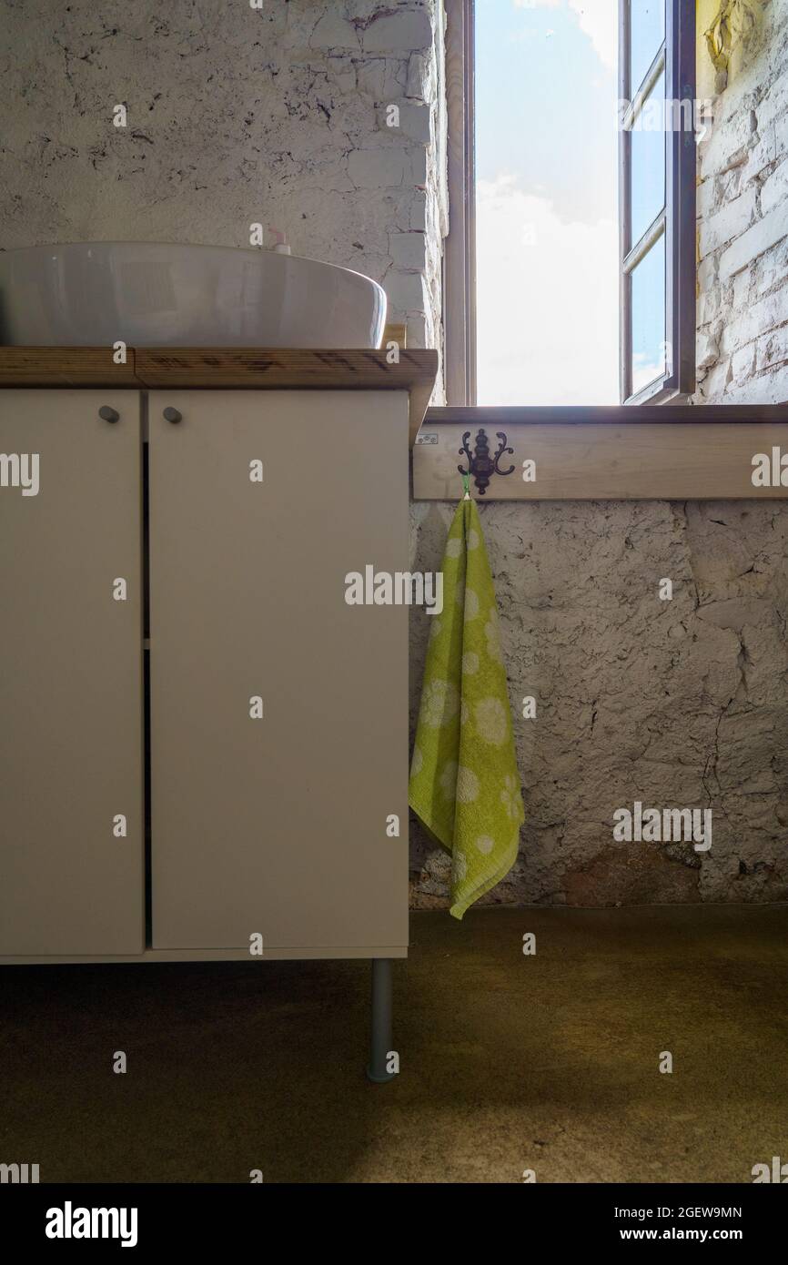 old brick masonry building bathroom with sink and sink cabinet, open ...