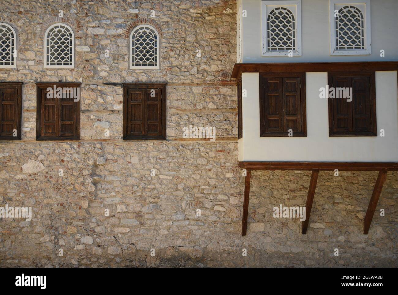 Traditional Balkan style mansion facade with a handcrafted stone wall ...