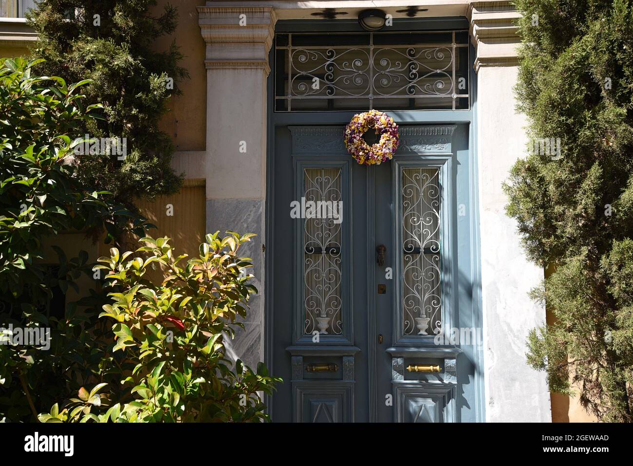 Old Neoclassical house entrance door with handcrafted iron grilles and ...