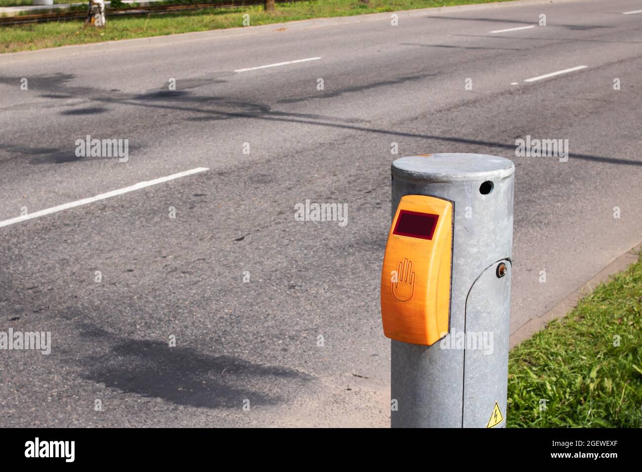 Yellow traffic light button on road background close up Stock Photo - Alamy