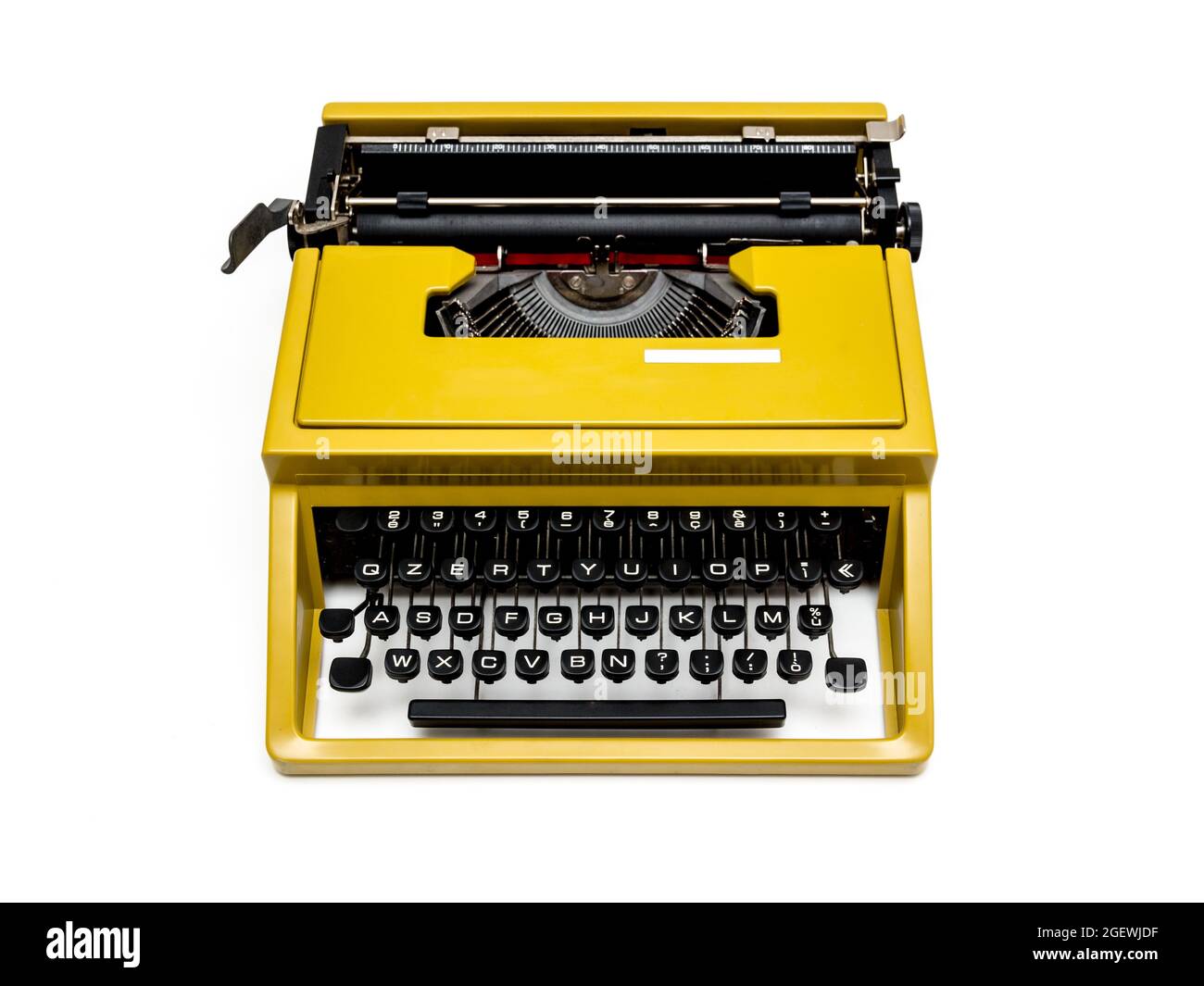 Studio photo of a vintage mustard yellow typewriter on a white ...