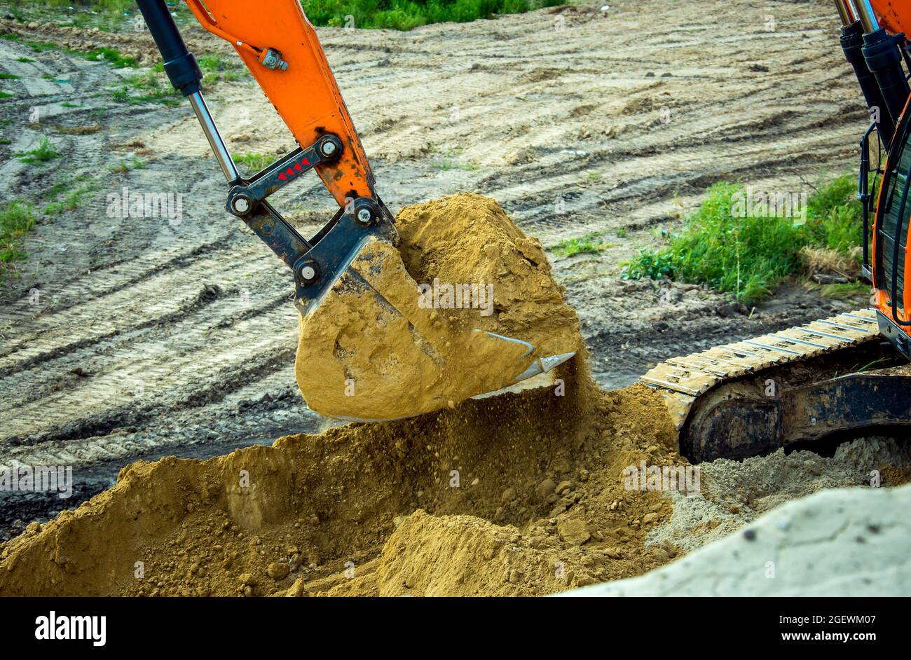 Closeup bucket of backhoe digging the soil at construction site ...