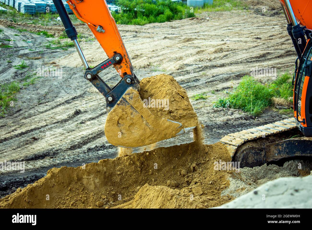 Closeup bucket of backhoe digging the soil at construction site ...