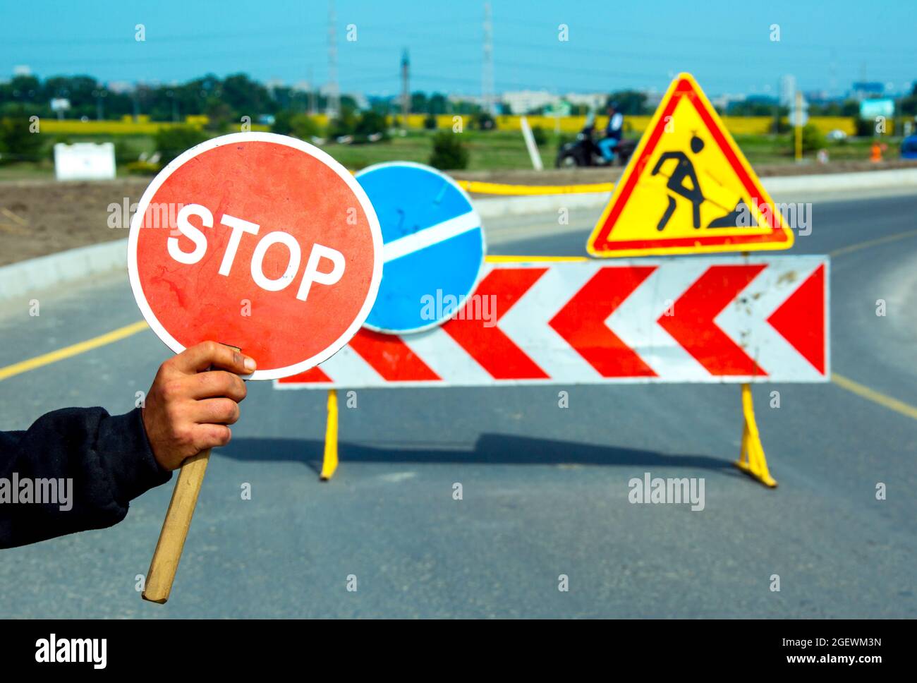 Worker holding a stop sign during road construction. Road construction ...