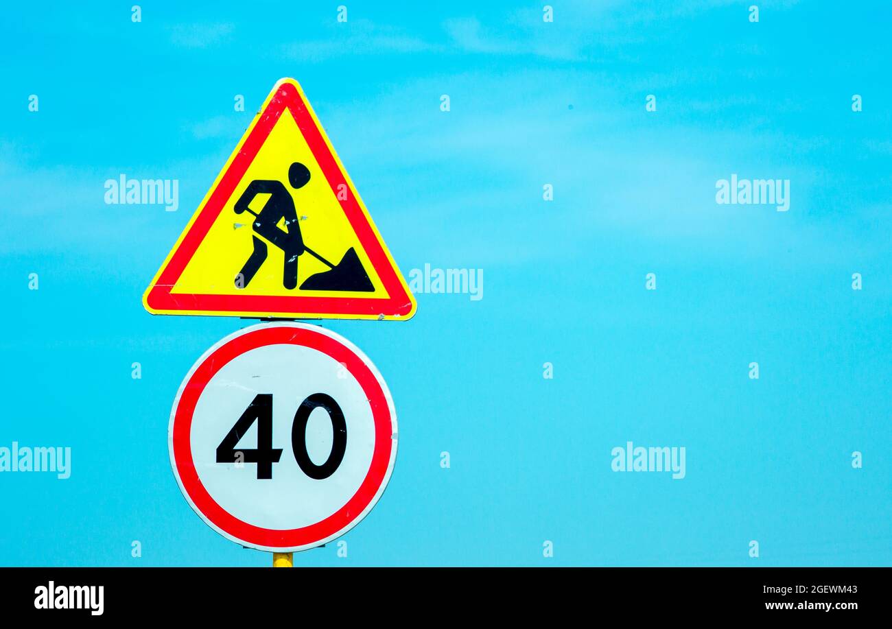 Road sign: speed limit 40 km/h in combination with road works ahead ...